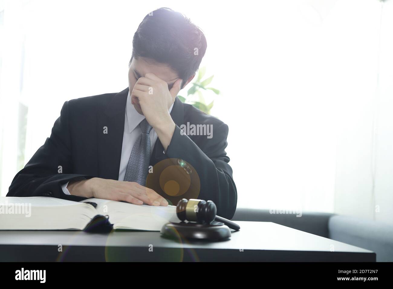 Tired lawyer sitting on desk Stock Photo - Alamy