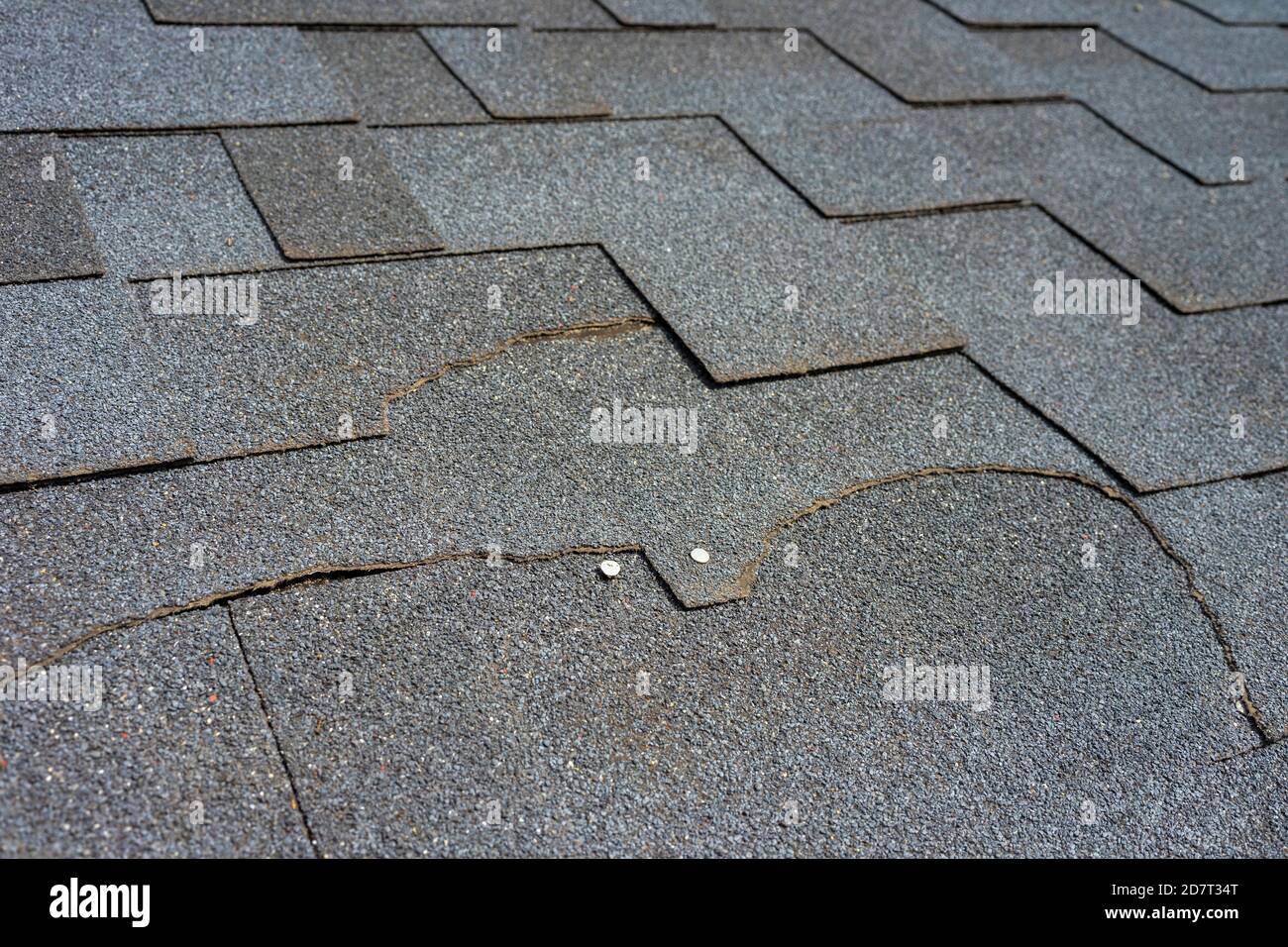 Сlose up view of bitumen shingles roof damage that needs repair Stock ...