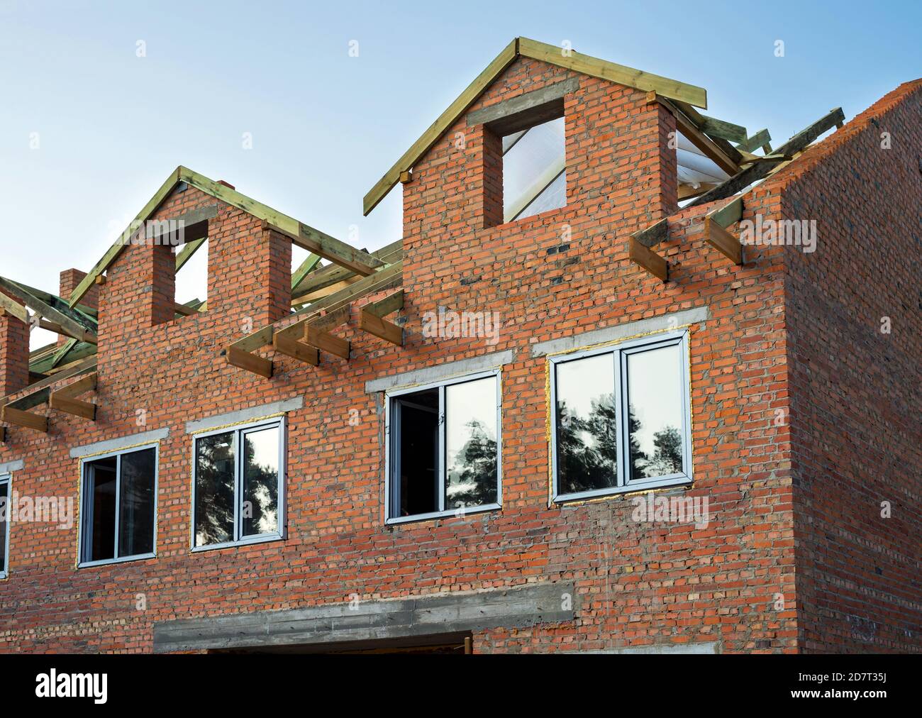Unfinished house of brick, still under construction before installing ...