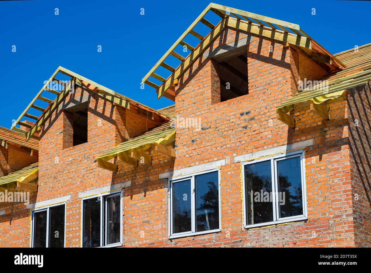 Unfinished house of brick, still under construction before installing ...