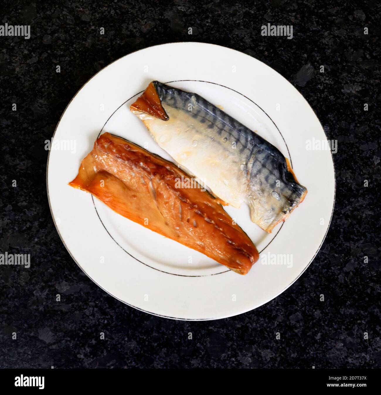 Two smoked mackerel fillets on a white plate Stock Photo - Alamy