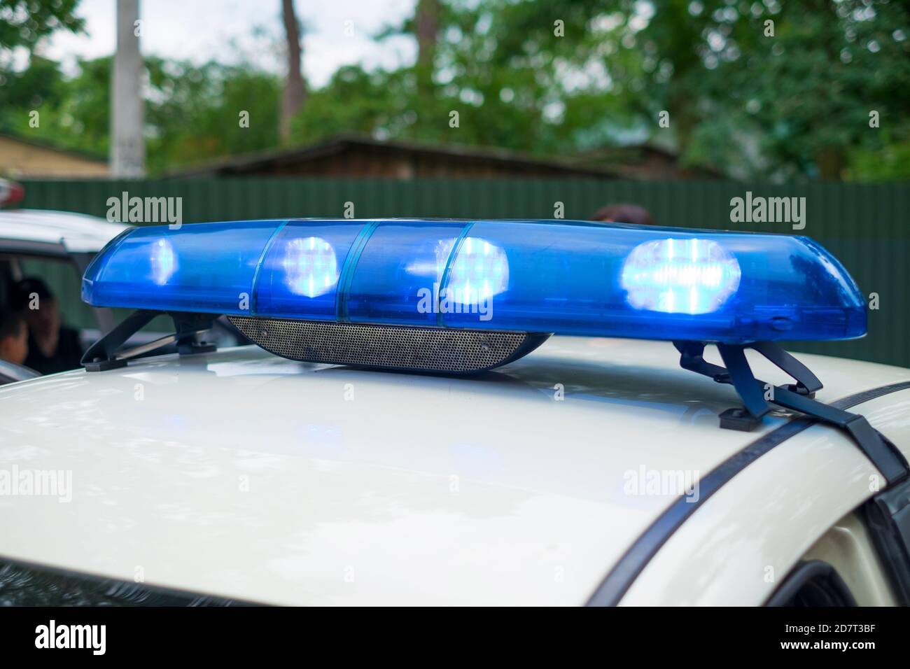 Patrol police car with blue lights on the street. Patrolling the city ...