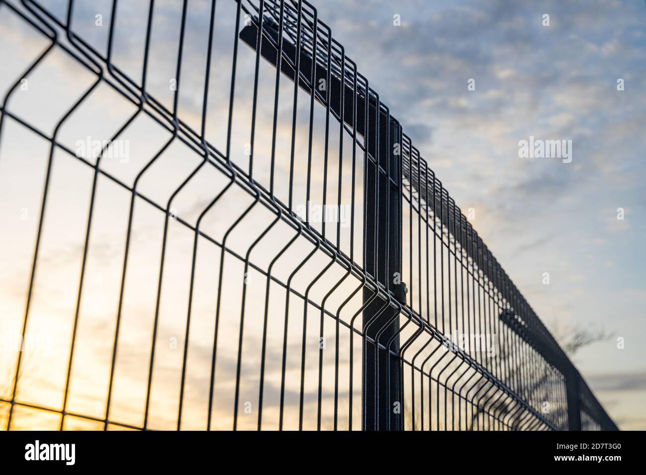 Steel grating fence made with wire on blue sky background. Sectional ...