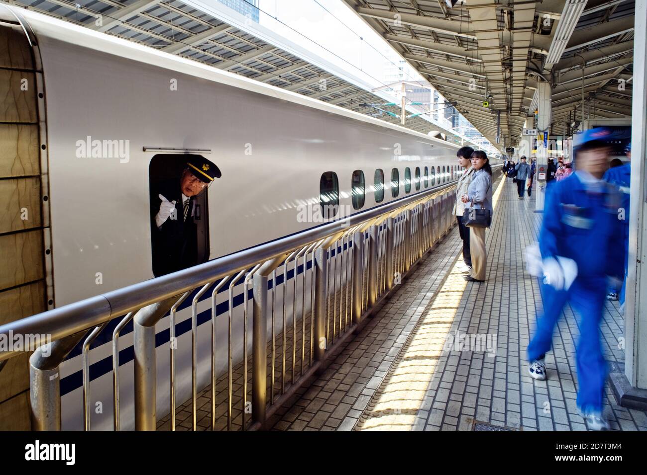 Ticket officer at the windows of Nozomi Shinkansen train, Tokyo station ...