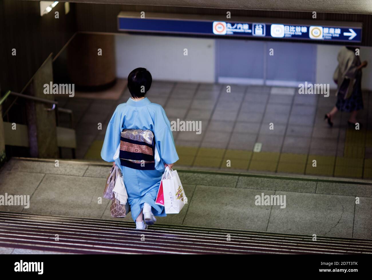 Japanese woman dressed in kimono and Obi walking in the subway of Ginza ...