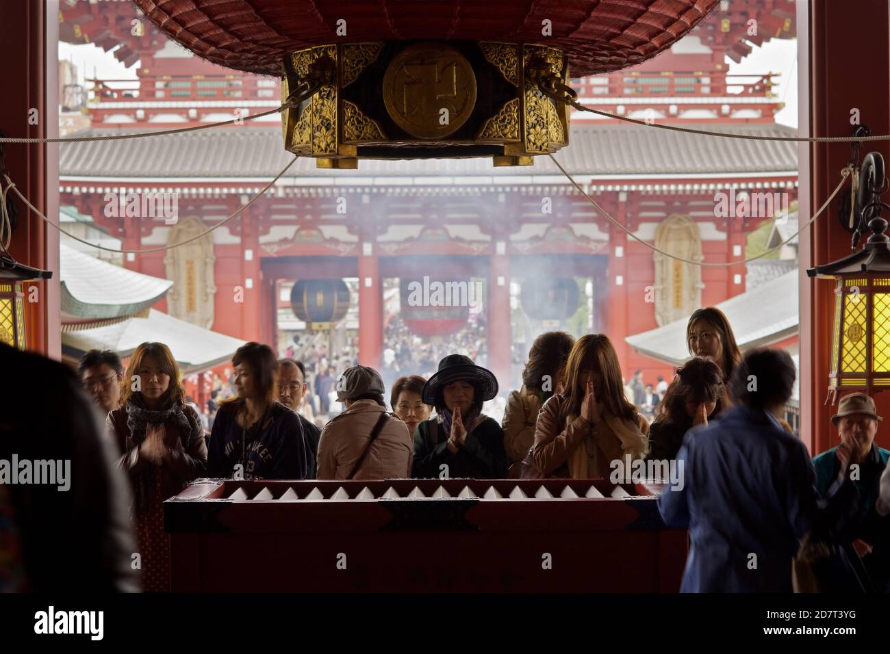 Japanese people praying in a Shinto shrine at Senso-ji temple, Asakusa ...