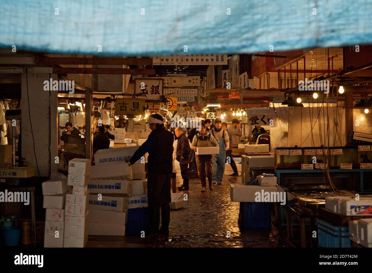 Fishmonger carrying fish cases at Tsukiji fish market, Tokyo, Japan ...