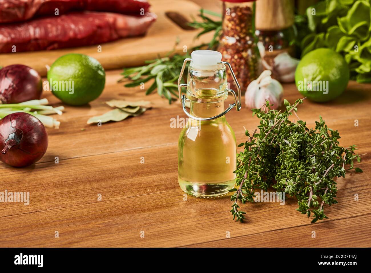 Small bottle of seed oil and bunch of thyme on wooden table Stock Photo ...