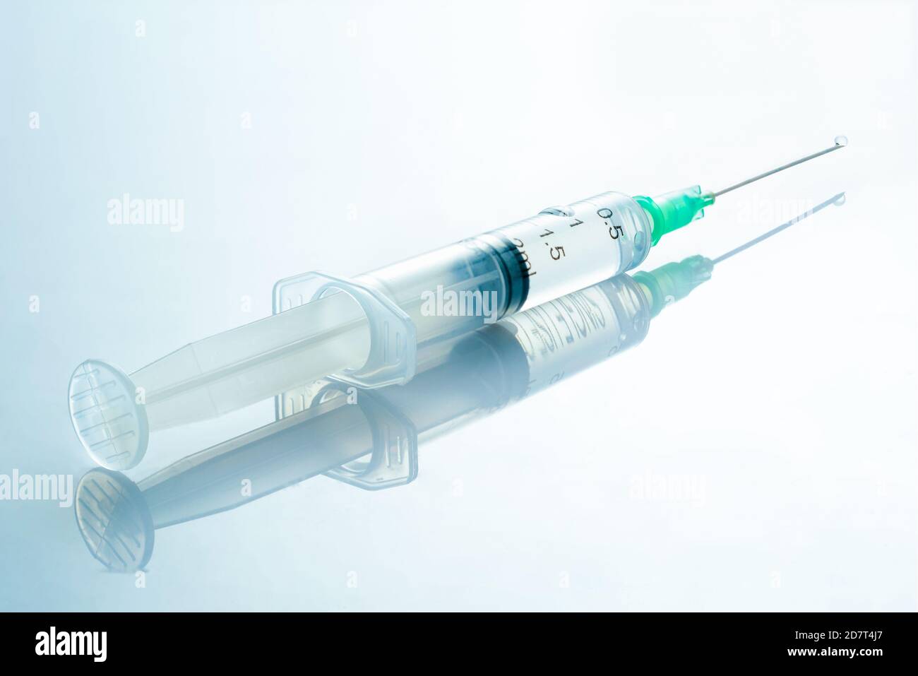 Syringe with medicinal solution, on a light blue background with ...
