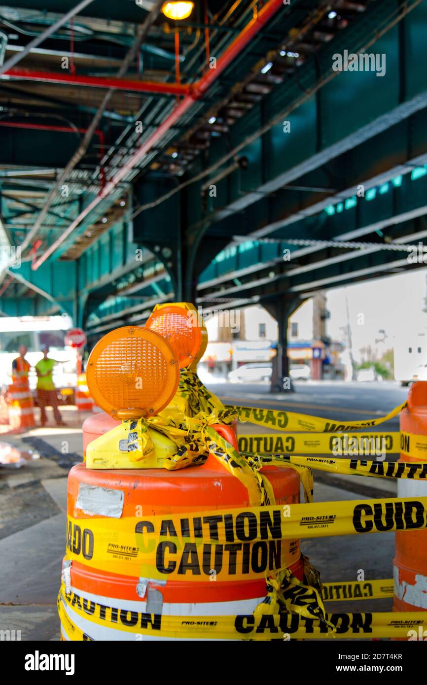 Closeup of a construction sign in the middle of the road under the NYC ...