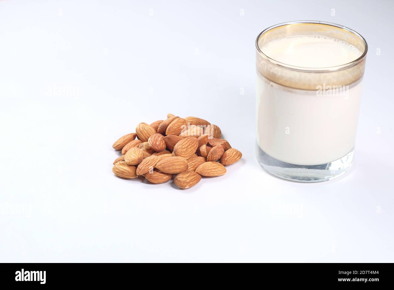 almond nut and milk white background with copy space Stock Photo - Alamy