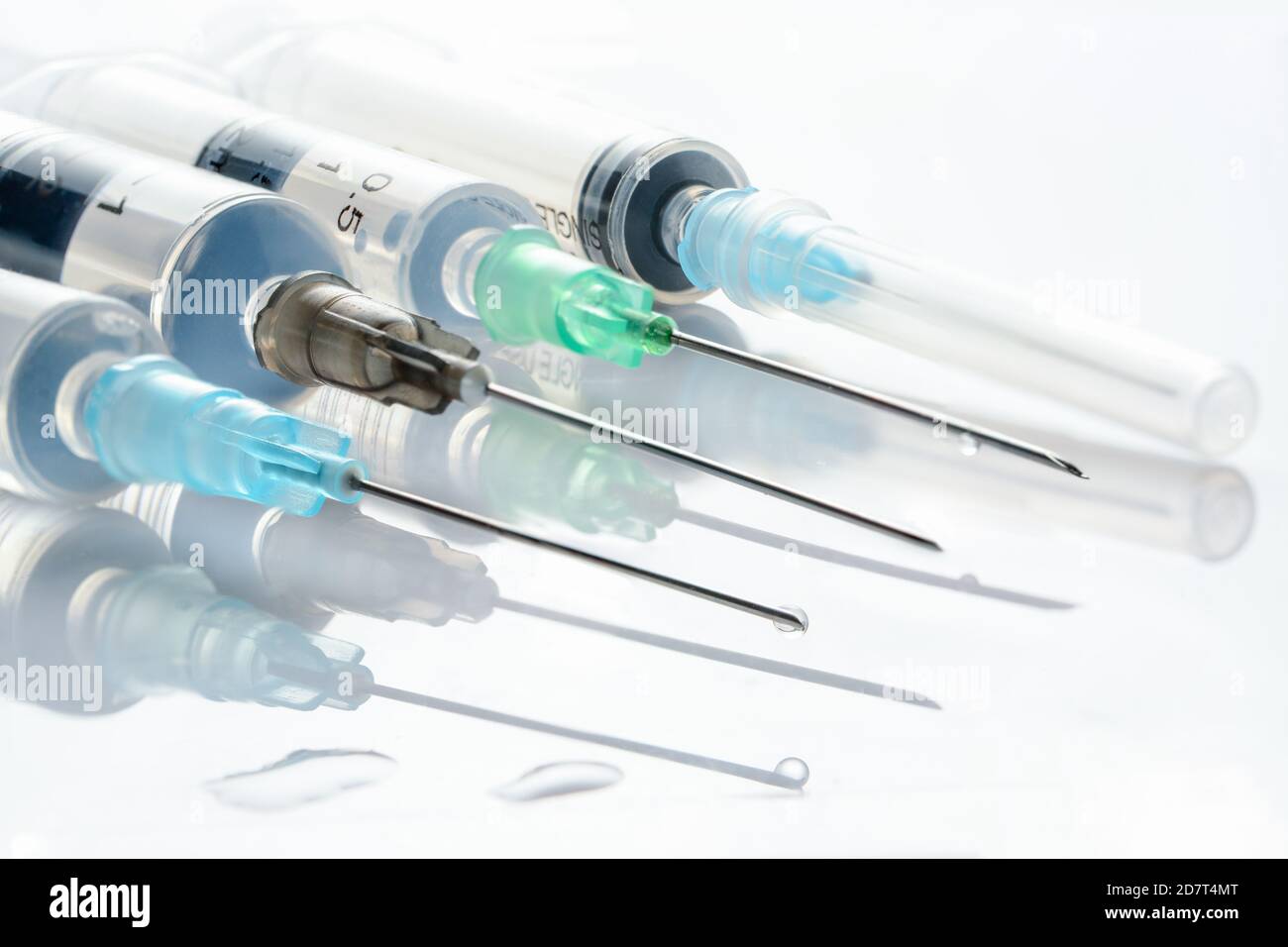 Four syringes with medicinal solution, on white background with ...