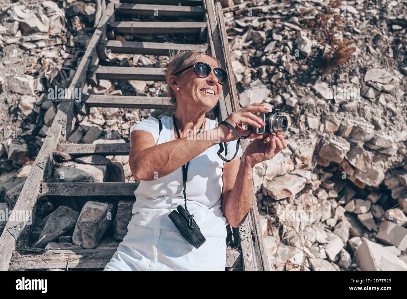 Elderly senior traveling backpacker mature woman tourist walking taking ...