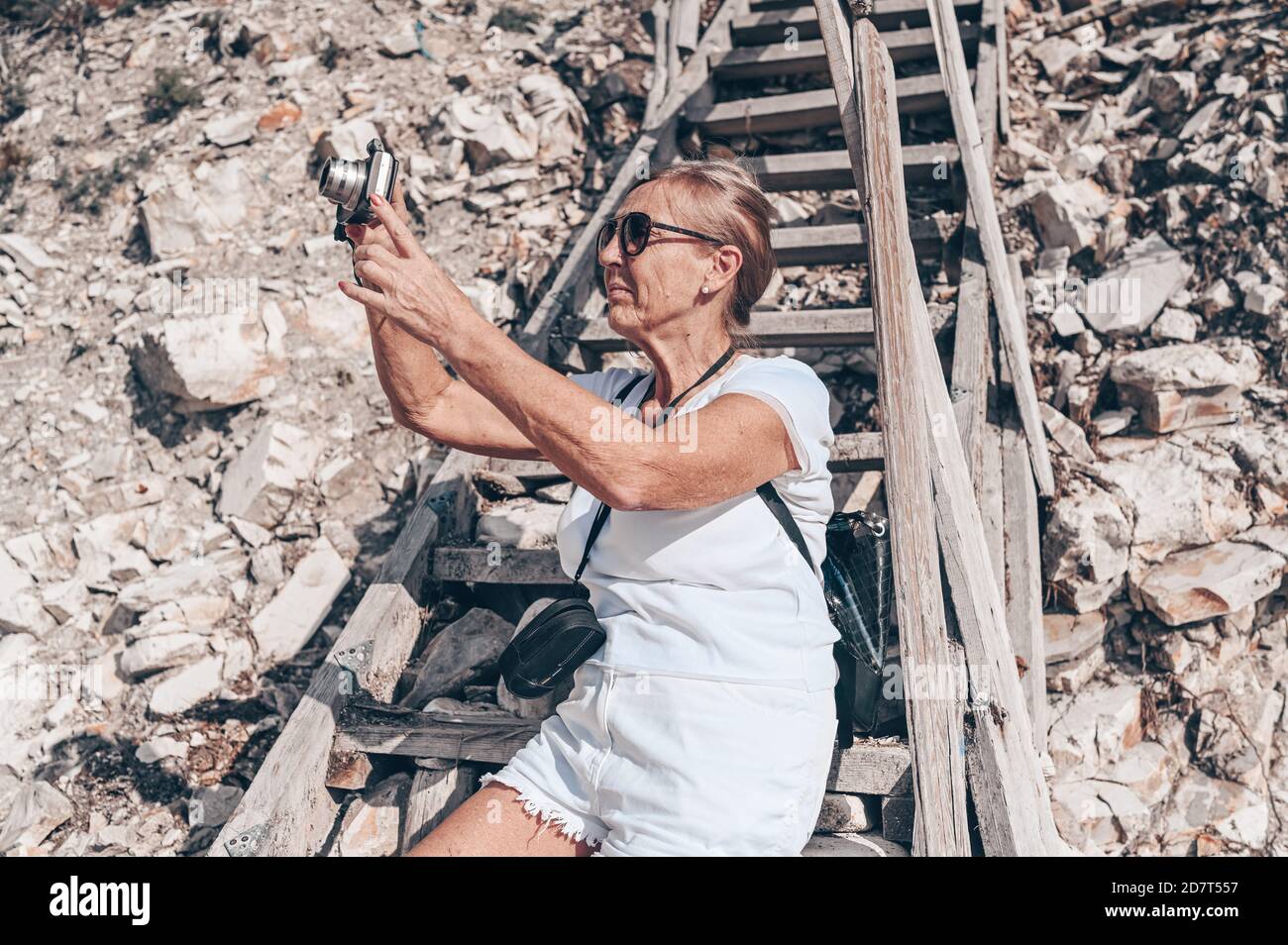 Elderly senior traveling backpacker mature woman tourist walking taking ...
