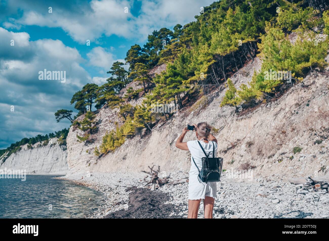 Elderly senior traveling backpacker mature woman tourist walking taking ...