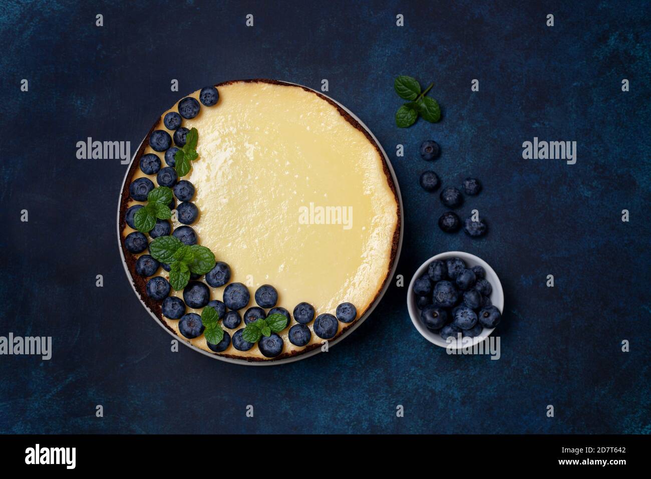 lemon cheesecake with blueberries on a blue background. view from above ...