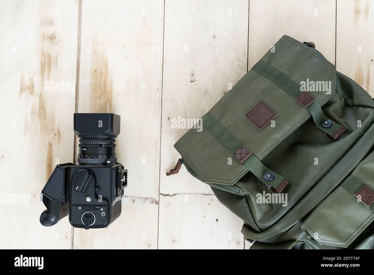 Top view of a backpack and a camera on the wooden surface - travel ...