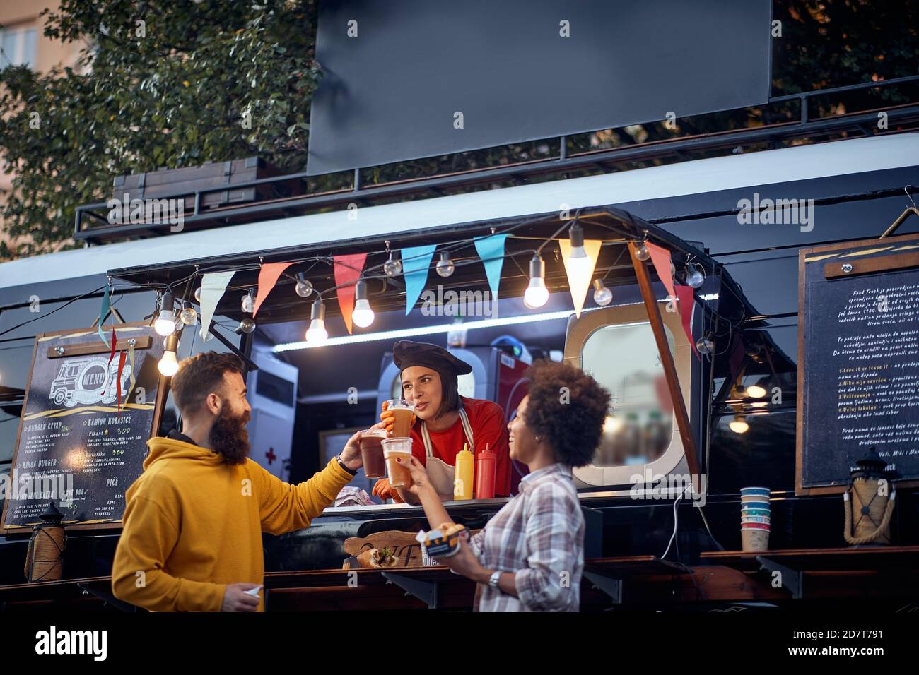 friends having a toast with a employee in front fast food service Stock ...