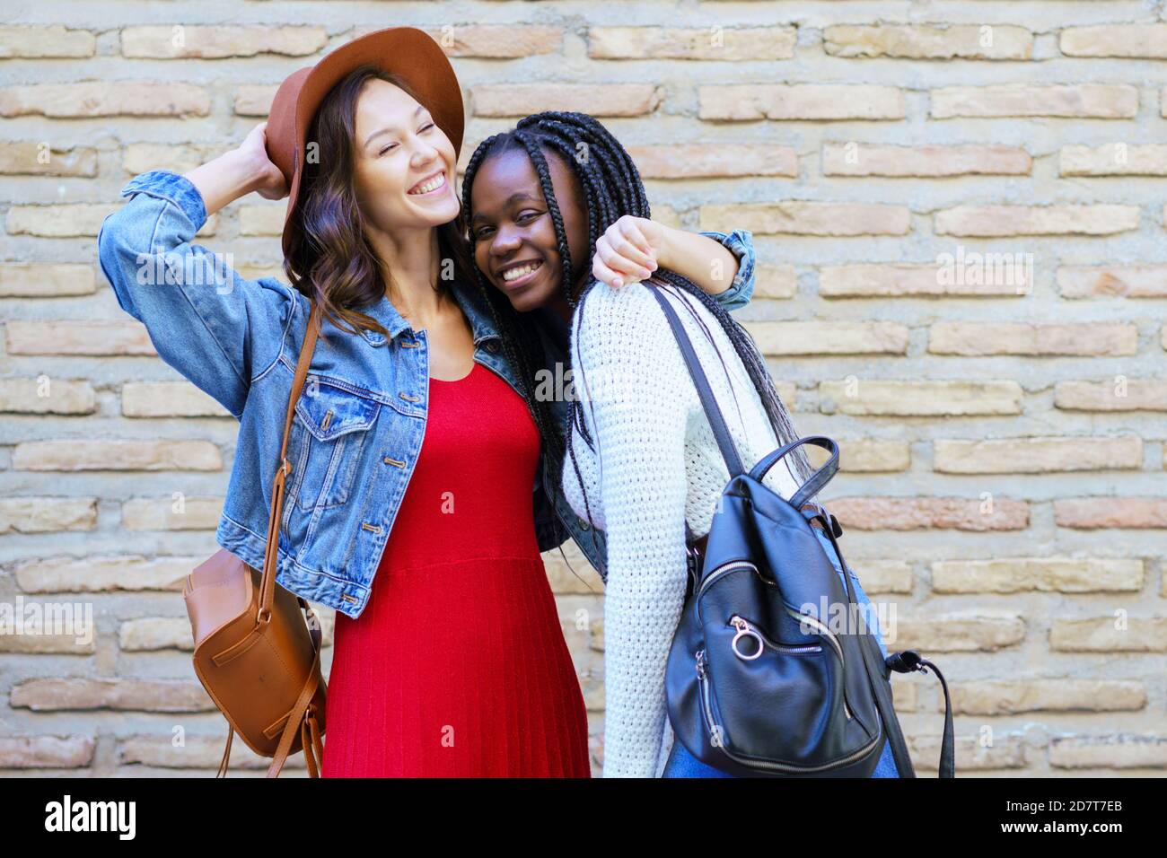 Two friends hugging in urban background. . Multiethnic friends Stock Photo - Alamy
