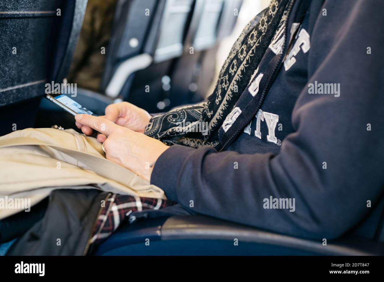 Selective focus shot of a person sitting using their cellphone Stock ...