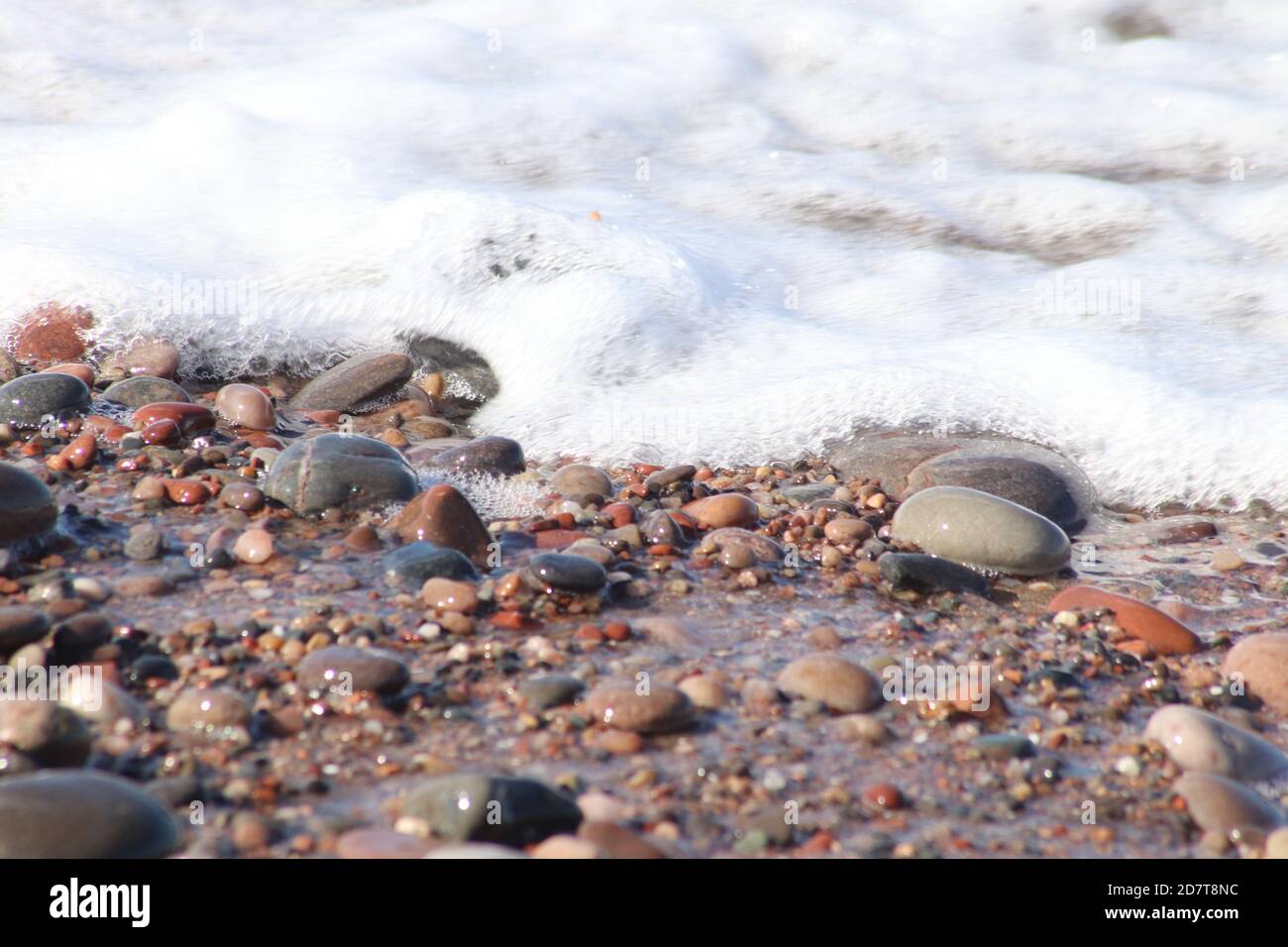 Waves on pebbles Stock Photo - Alamy