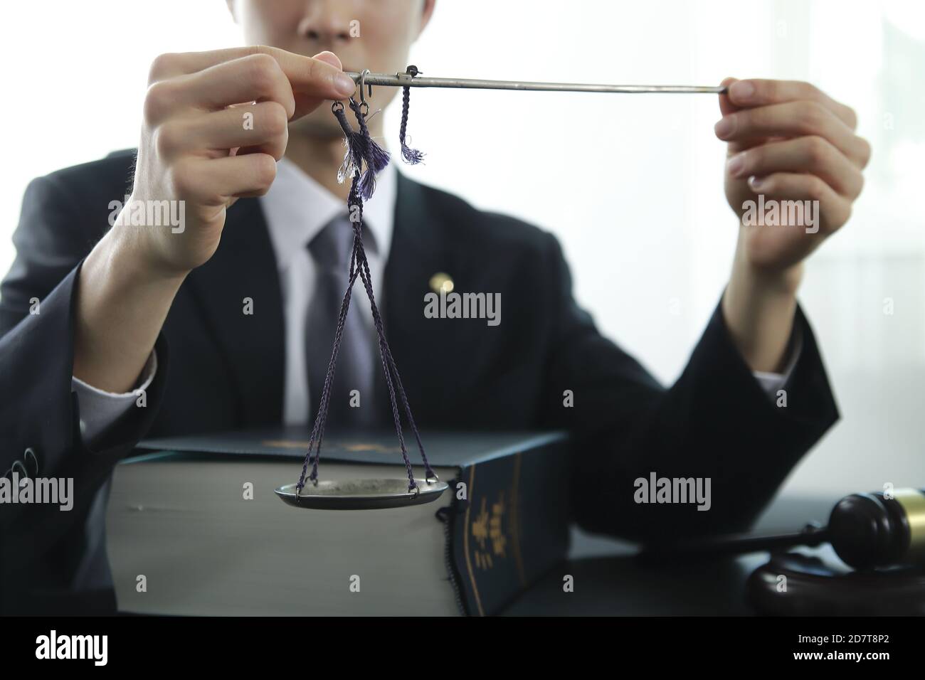 Lawyer holding justice scale.Chinese character 'beobjeon' means code of ...