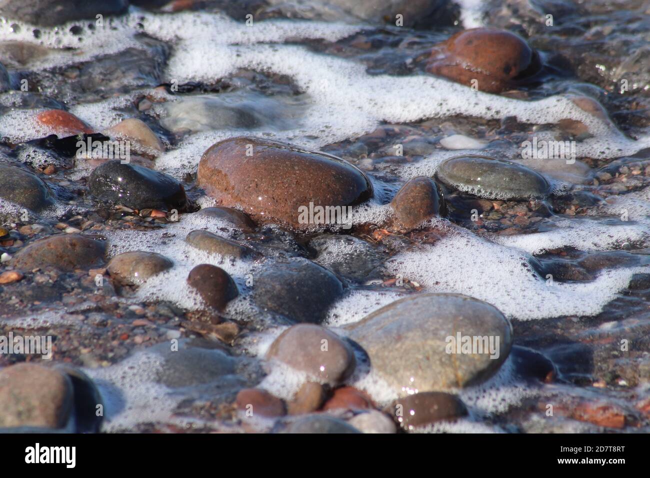 Waves on pebbles Stock Photo - Alamy