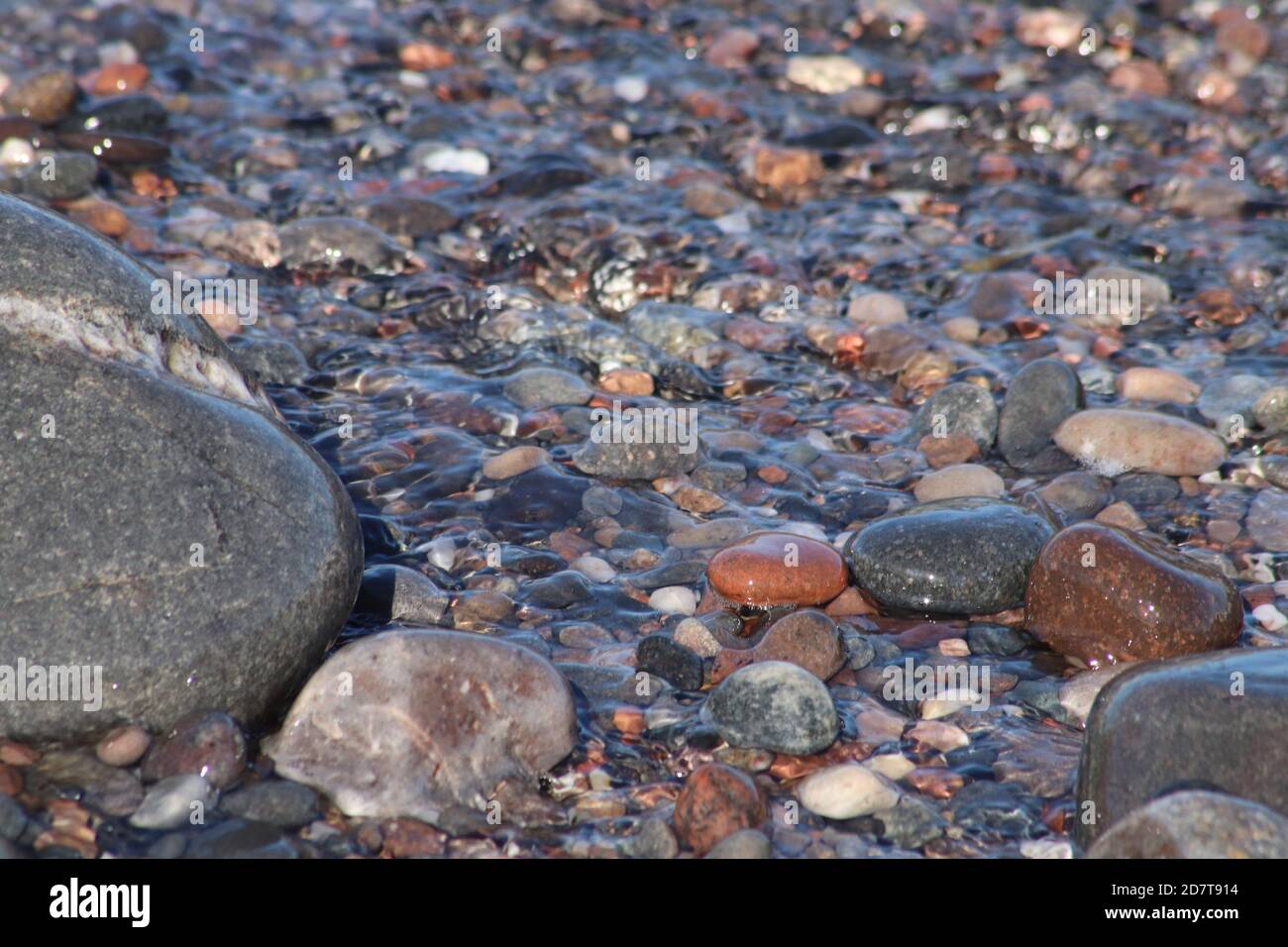 Waves on pebbles Stock Photo - Alamy