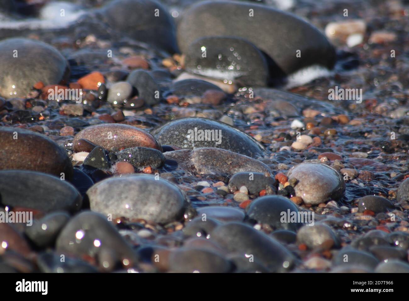 Waves on pebbles Stock Photo - Alamy