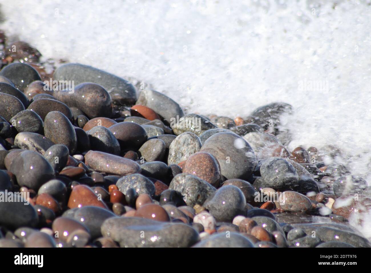 Waves on pebbles Stock Photo - Alamy