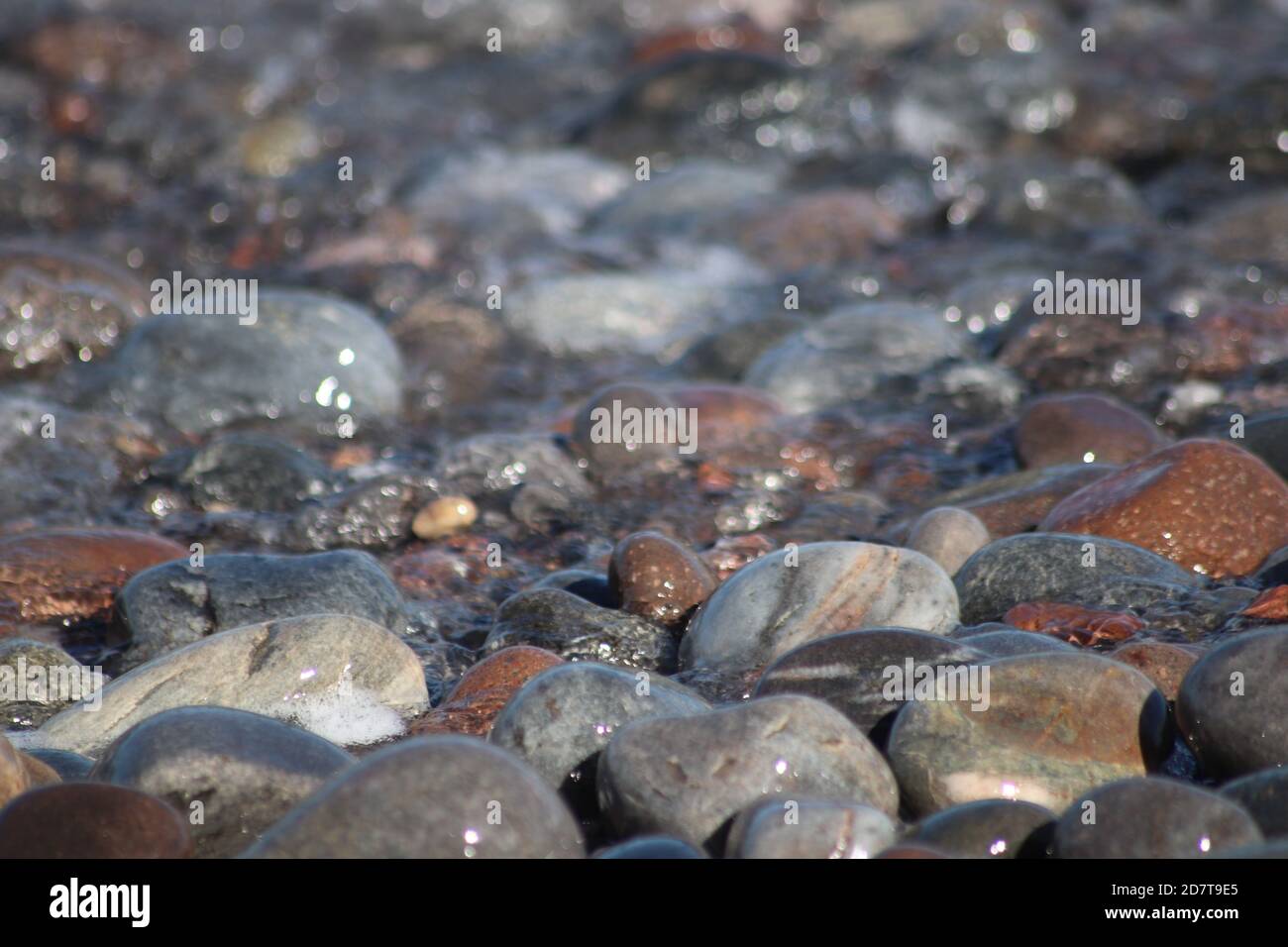 Waves on pebbles Stock Photo - Alamy