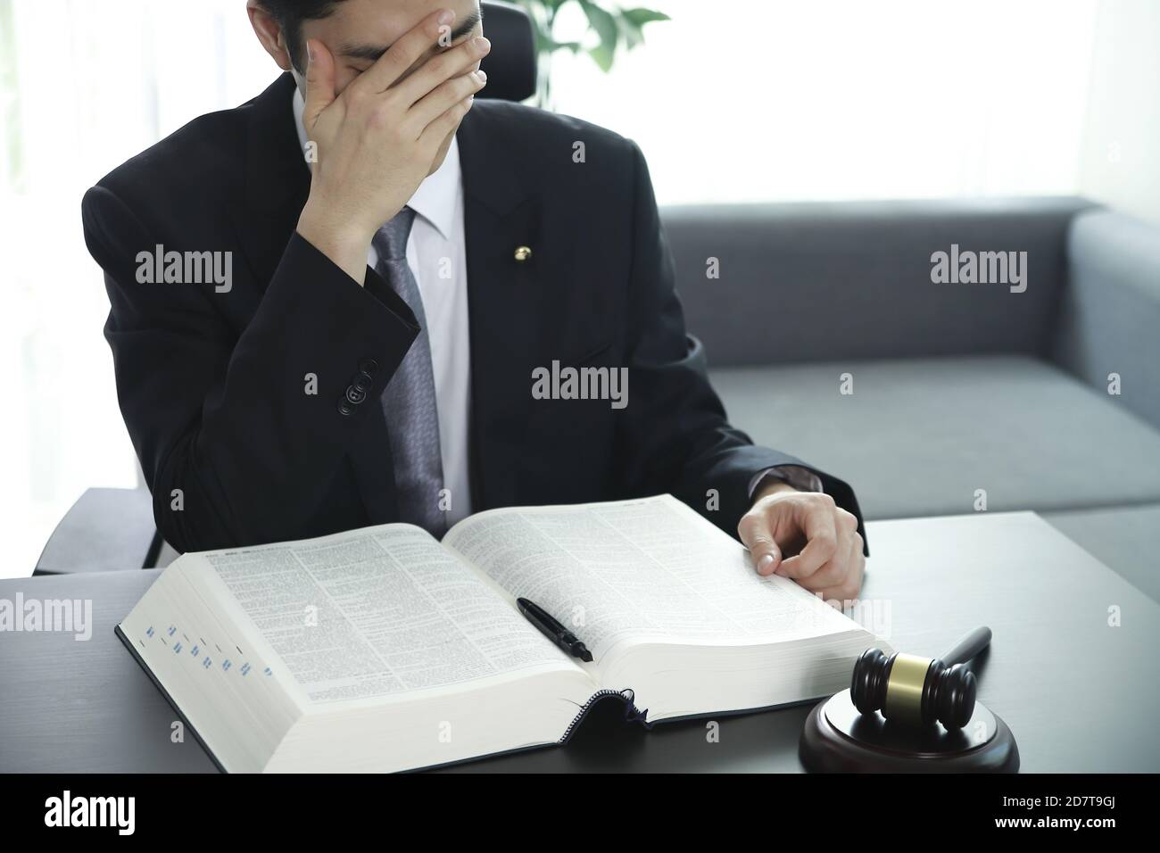 Tired lawyer sitting on desk Stock Photo - Alamy