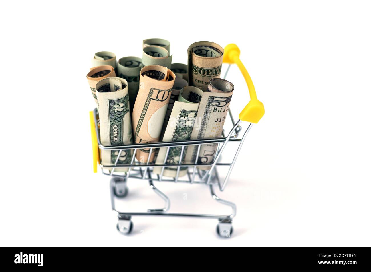 Small shopping cart filled with Dollars cash. Dollars in yellow ...