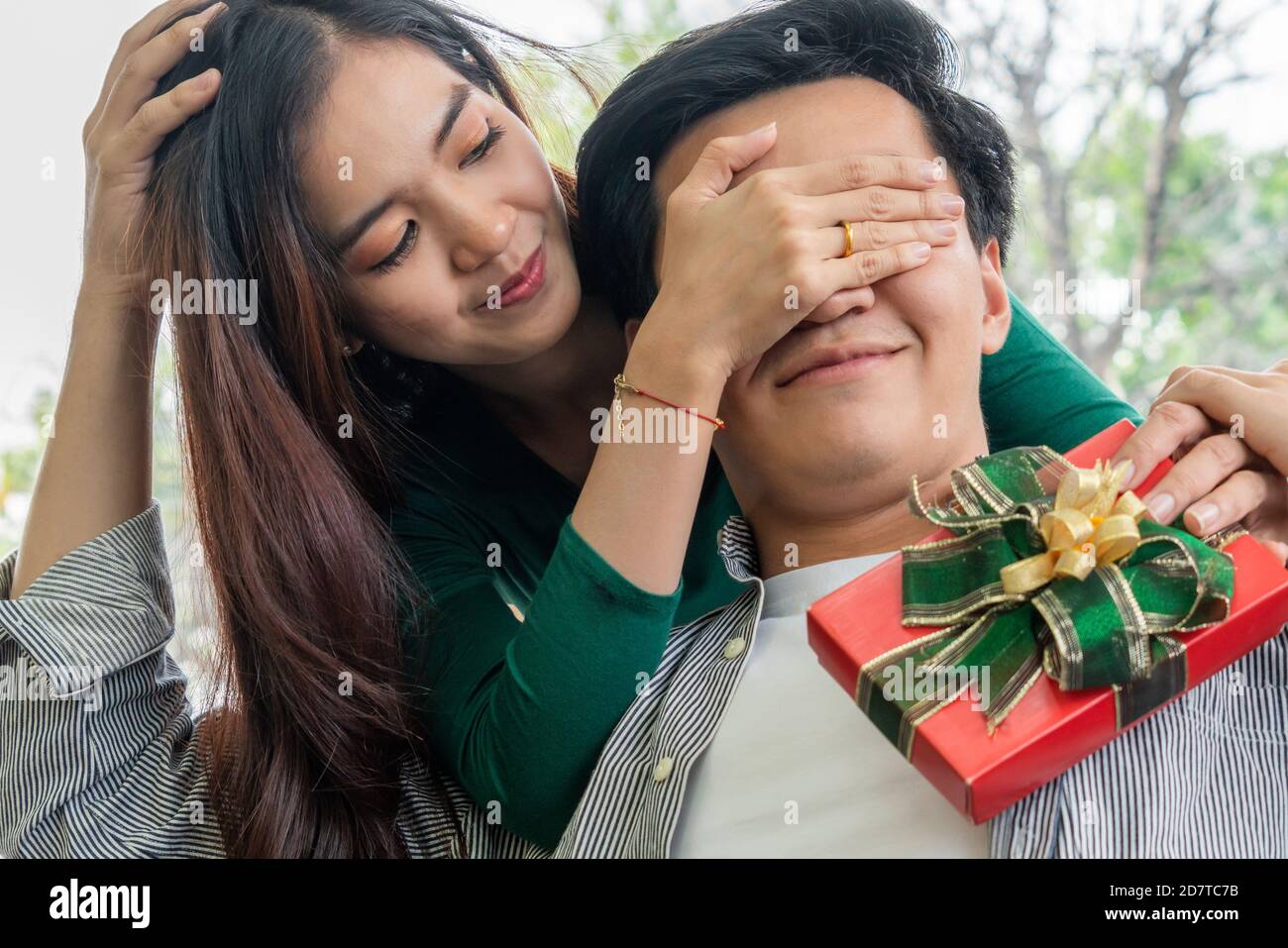 Happy couple giving gift present to celebrate anniversary. Marriage ...