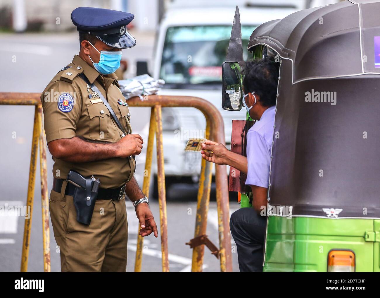 Colombo, Sri Lanka. 25th Oct, 2020. Sri Lankan police officers check vehicles in a checkpoint ...