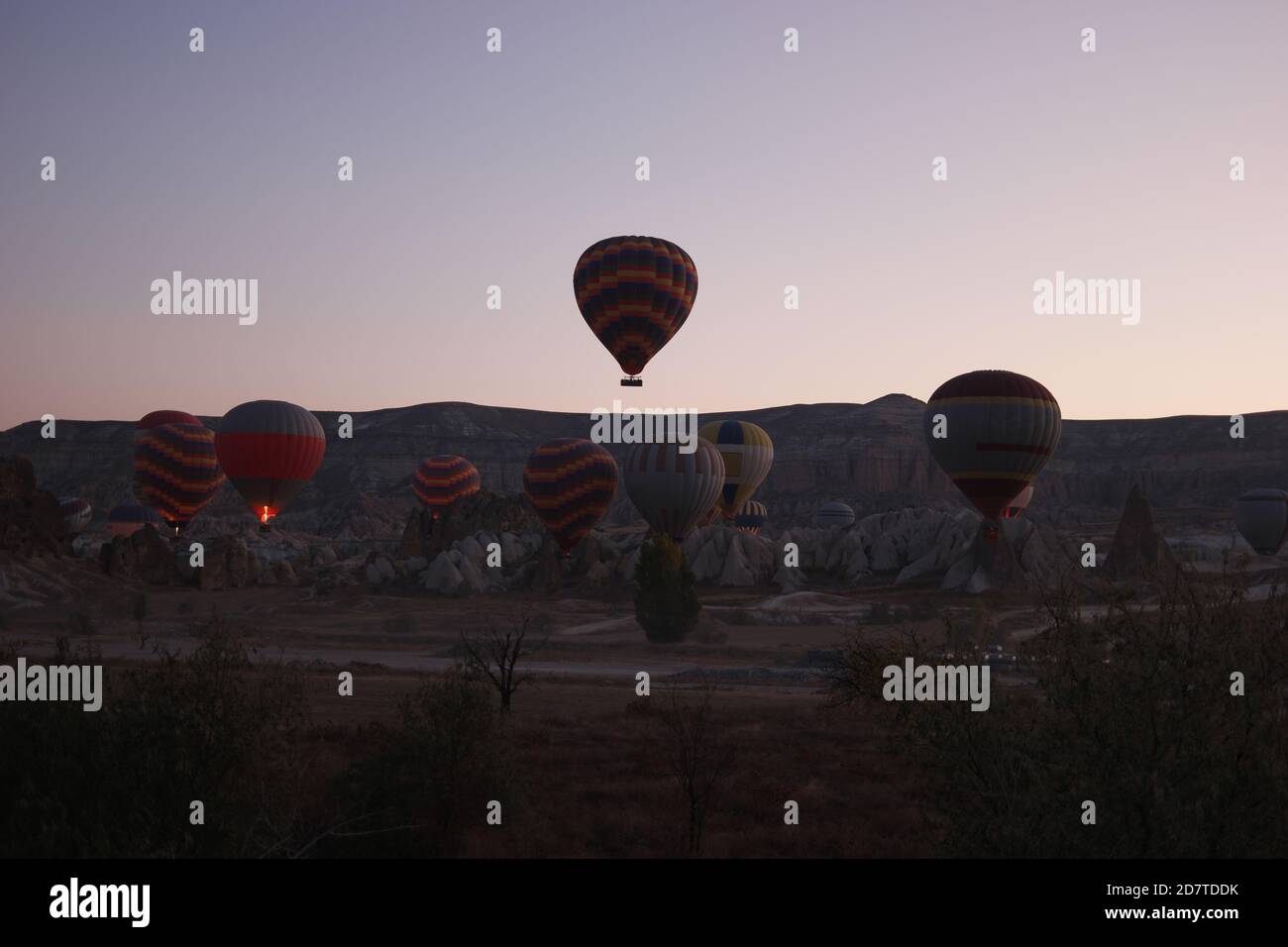 Hot air balloons in sunset sky Stock Photo - Alamy