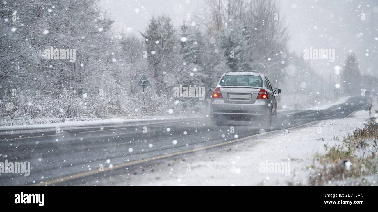 The car is driving on a winter road in a blizzard Stock Photo - Alamy