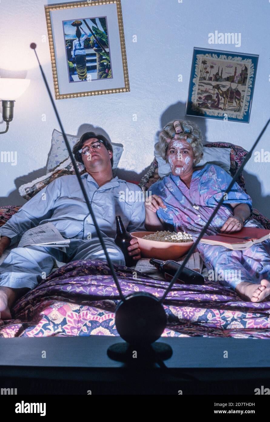 Goofy Couple Watching TV in Bed, USA Stock Photo - Alamy