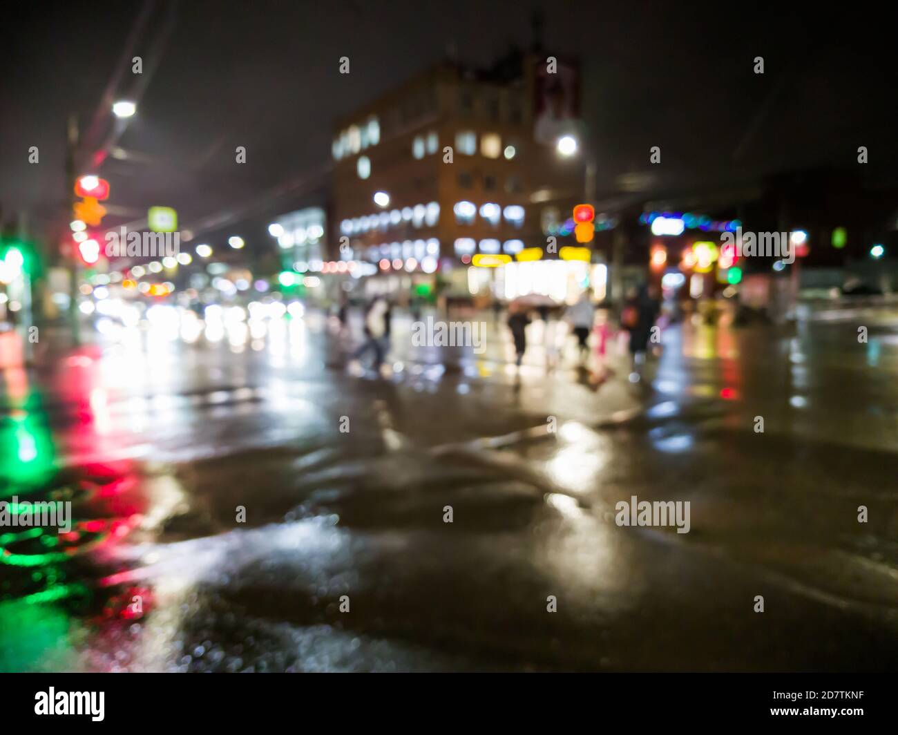 defocused night rain city street view with cars crossing road Stock ...