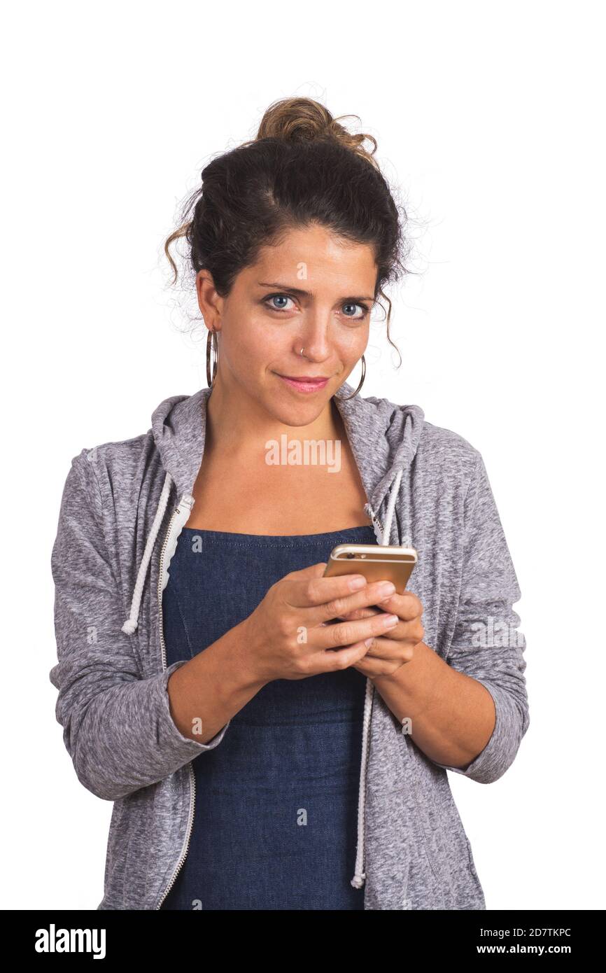 Portrait of young beautiful woman using her mobile phone in studio ...