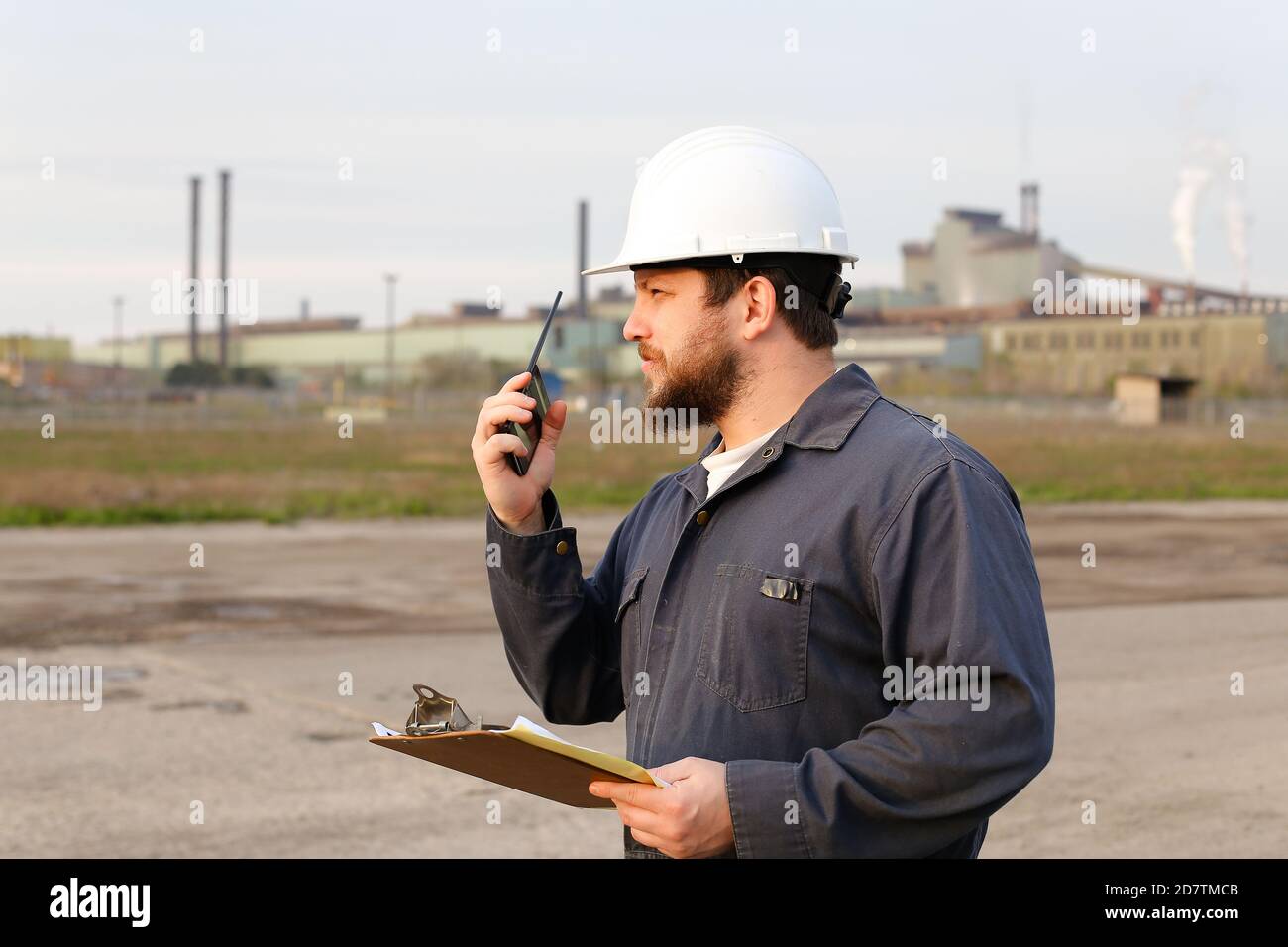 Portrait of industrial engineer standing on construction site and ...