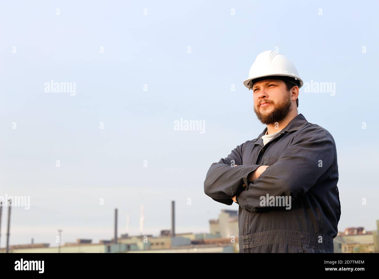 Portrait of american foreman in helmet standing in construction site ...