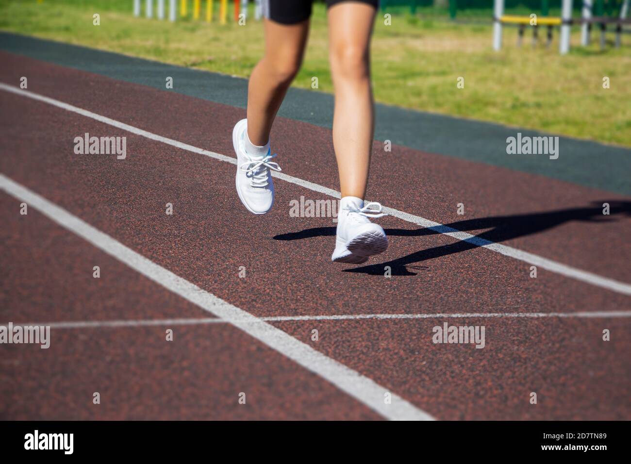 A runner's feet run along the road in close-up on their shoes. Running ...