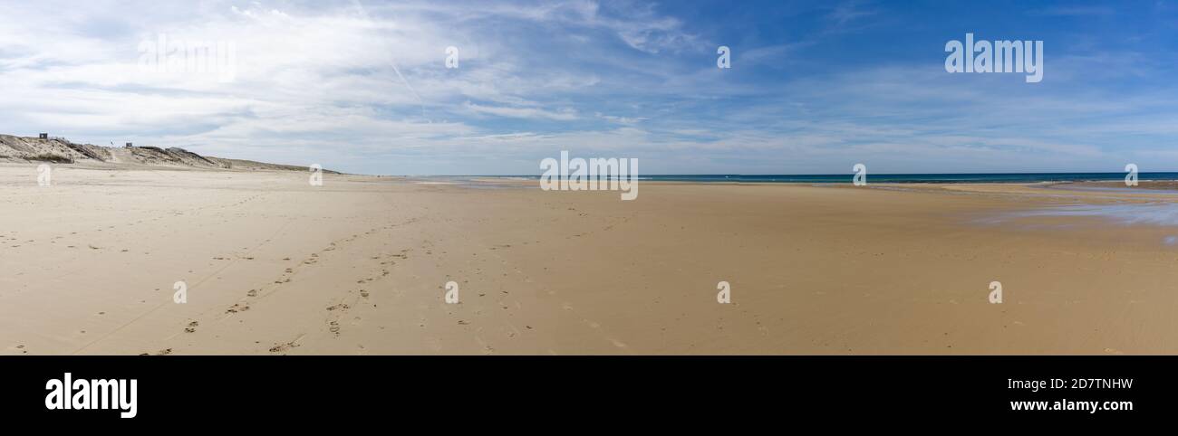 A wide empty beach and sand dunes on the Atlantic Ocean coast in France ...