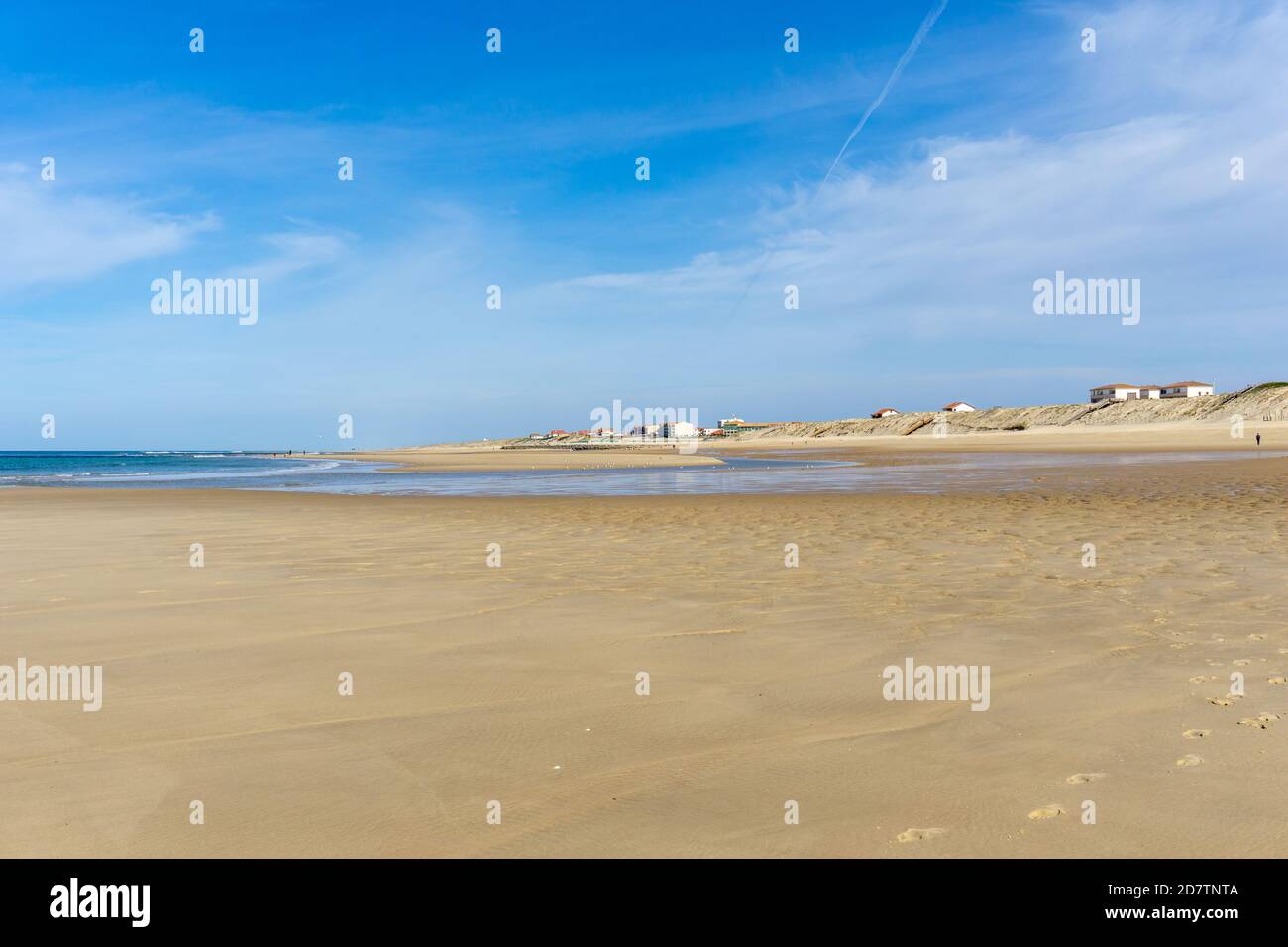 A wide empty beach and sand dunes on the Atlantic Ocean coast in France ...