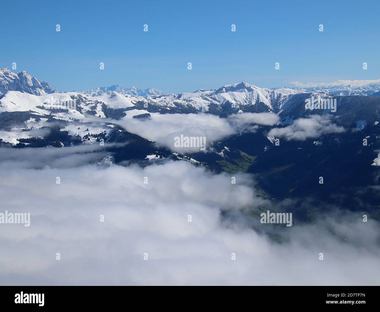 Snowy mountains rise above the mist Stock Photo - Alamy