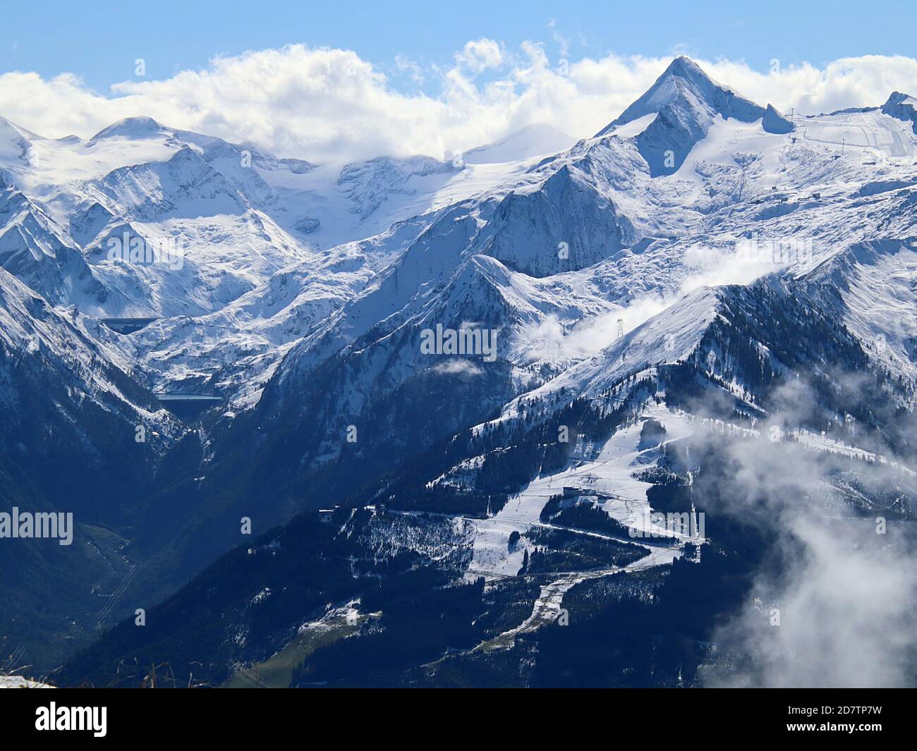Snowy mountains rise above the mist Stock Photo - Alamy
