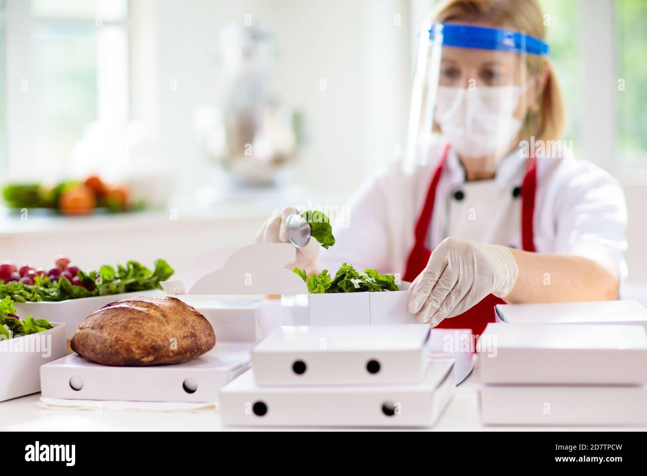 Food takeaway in restaurant in coronavirus outbreak. Cafe staff in face ...