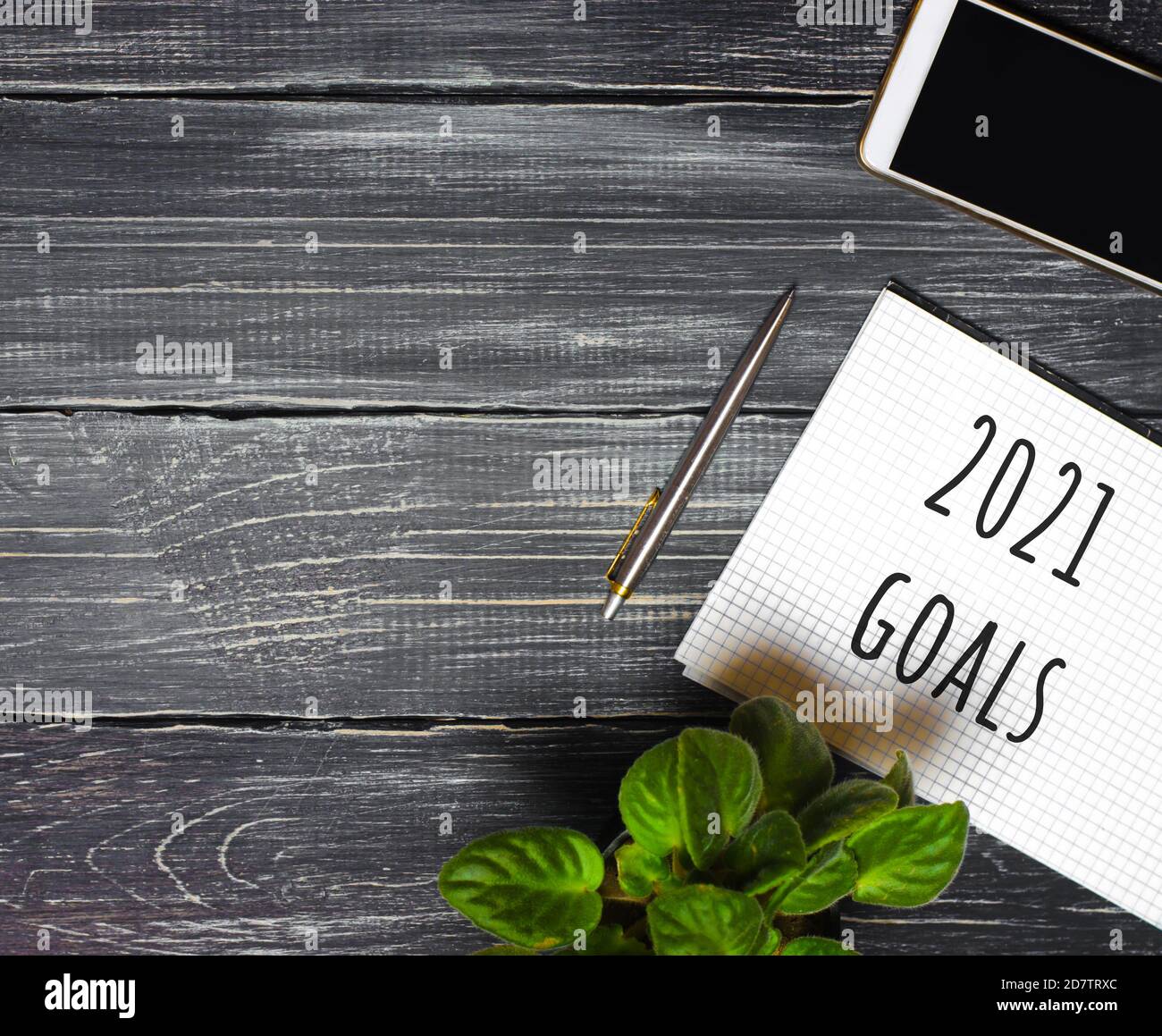 2021 Goals concept. Desktop with notebook, phone, pen. Motivation ...