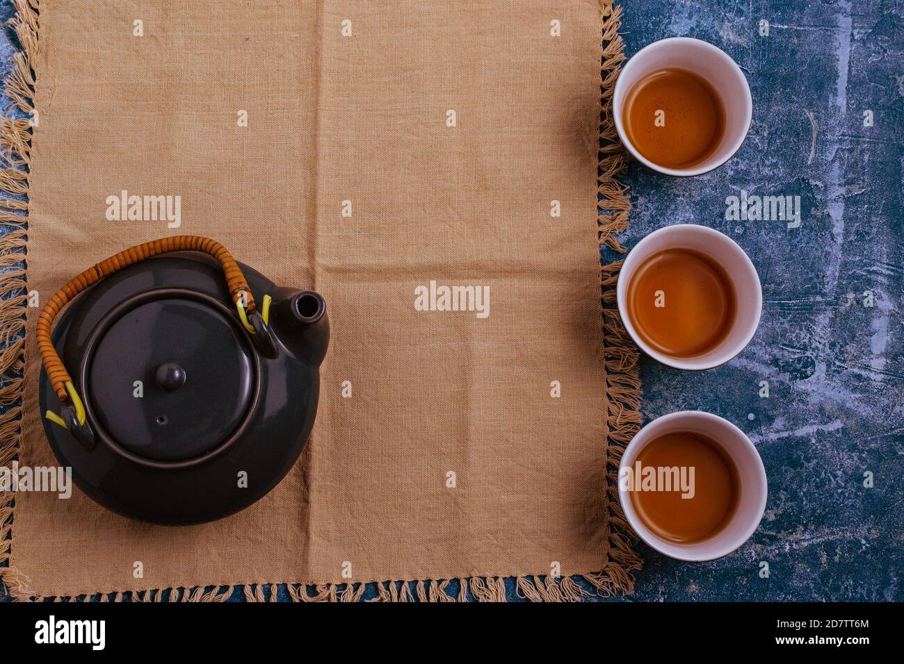Top view of a gray tea set on a decorative brown fabric Stock Photo - Alamy
